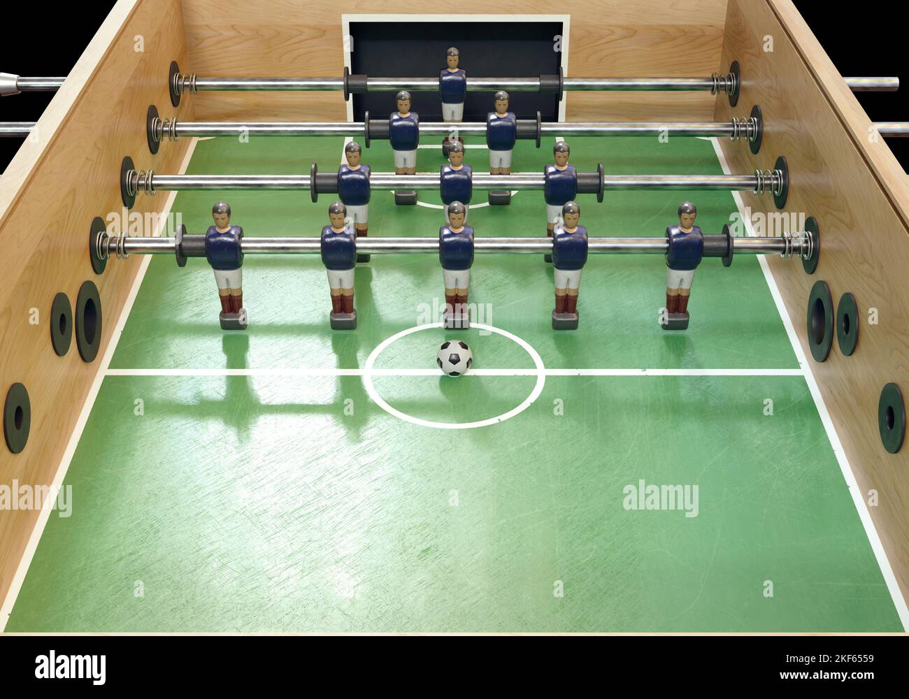 One side of a vintage foosball or table football table with worn metal ...