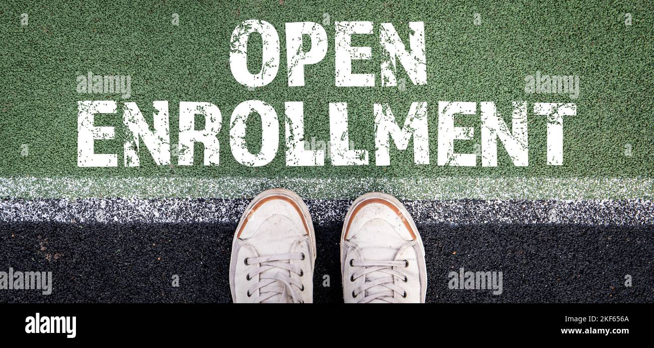 Open Enrollment concept. Starting line and shoes on a green and black ...