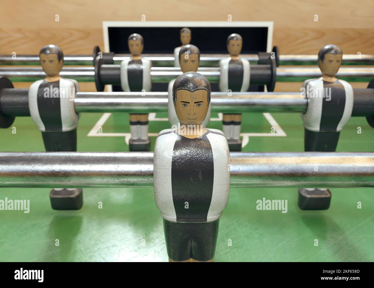 One side of a vintage foosball or table football table with worn metal ...