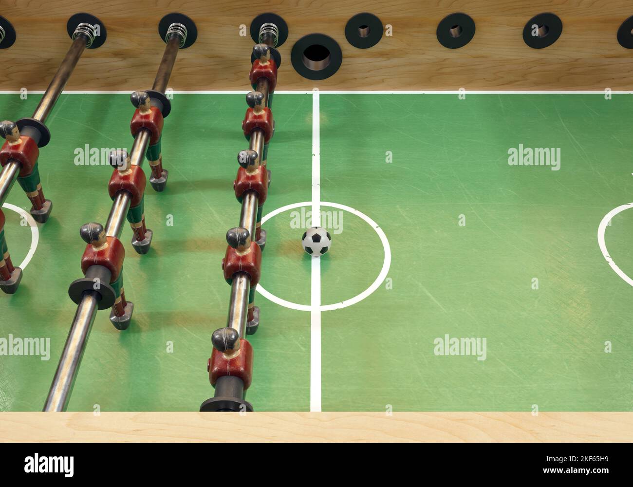 One side of a vintage foosball or table football table with worn metal ...