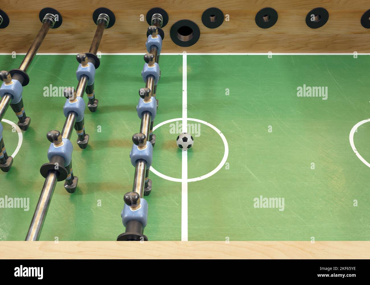 One side of a vintage foosball or table football table with worn metal ...