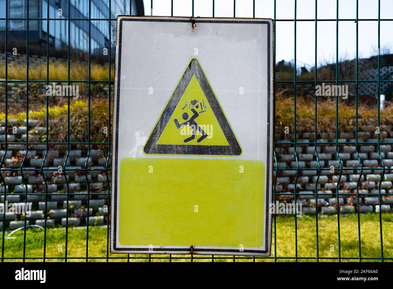 Yellow electric safety sign outside on metal gate Stock Photo - Alamy
