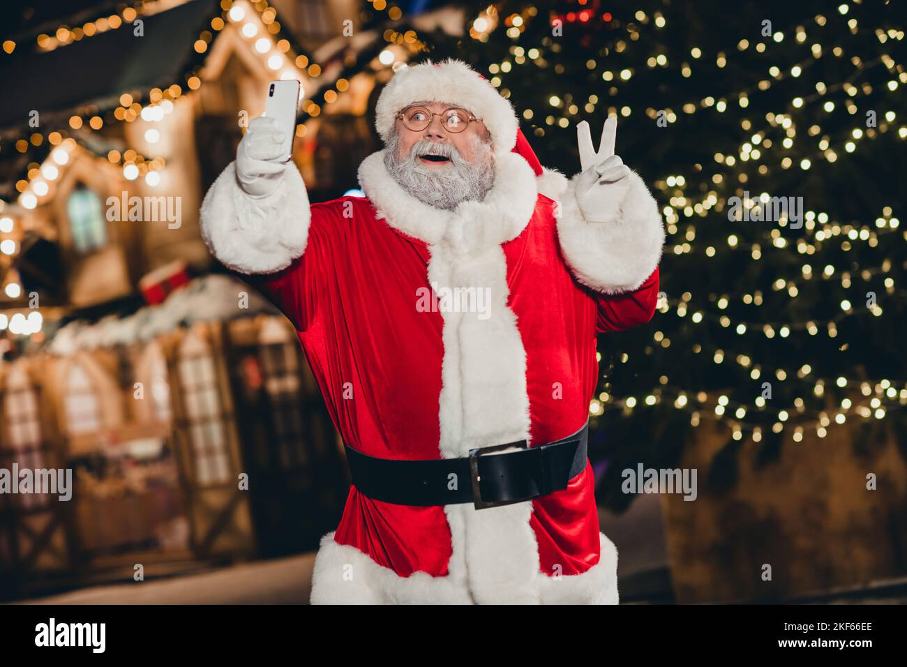 Photo of funky fat santa claus hold telephone take selfie photo show v ...