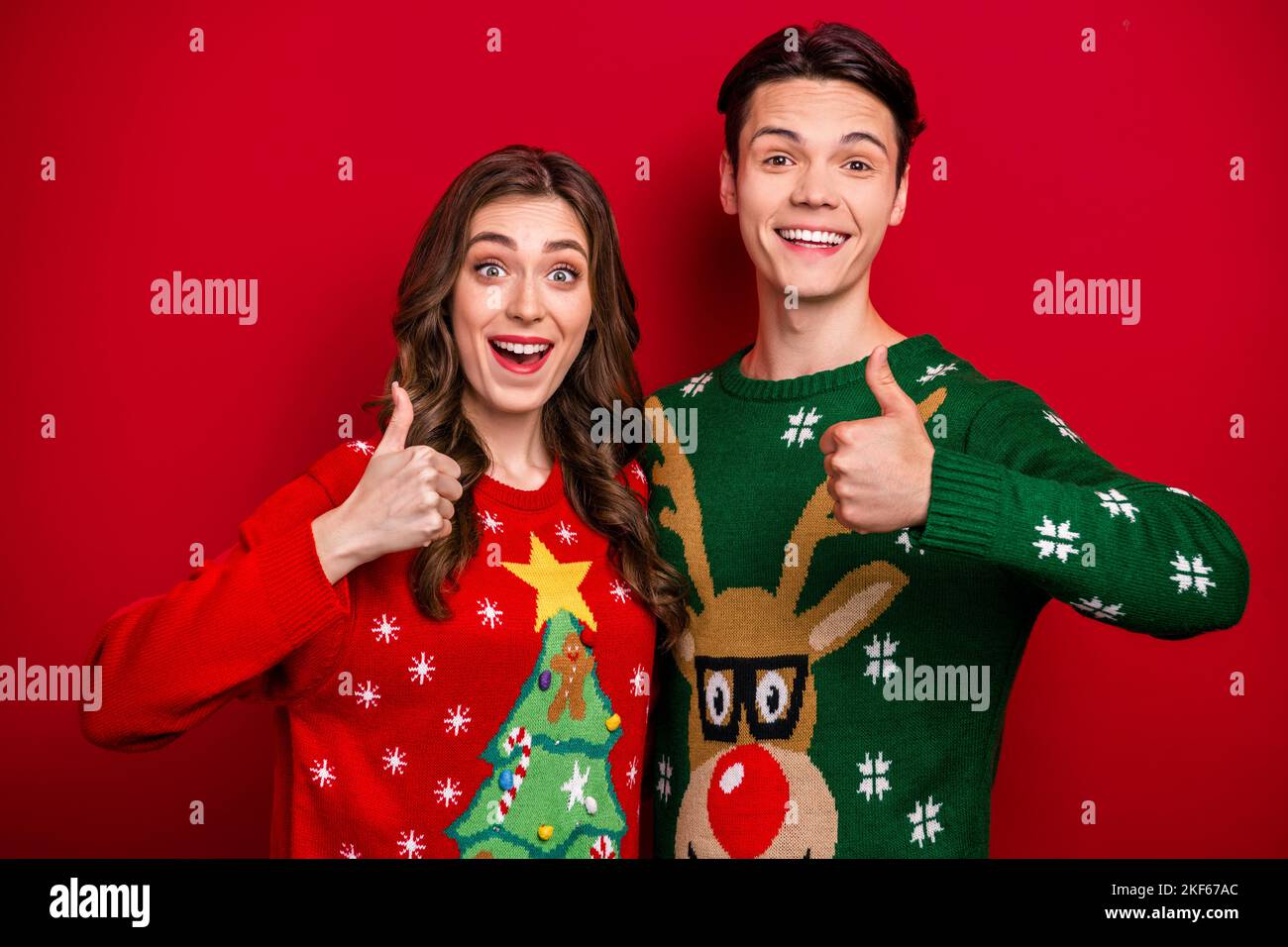 Photo of pretty excited best friends dressed x-mas jumpers showing ...