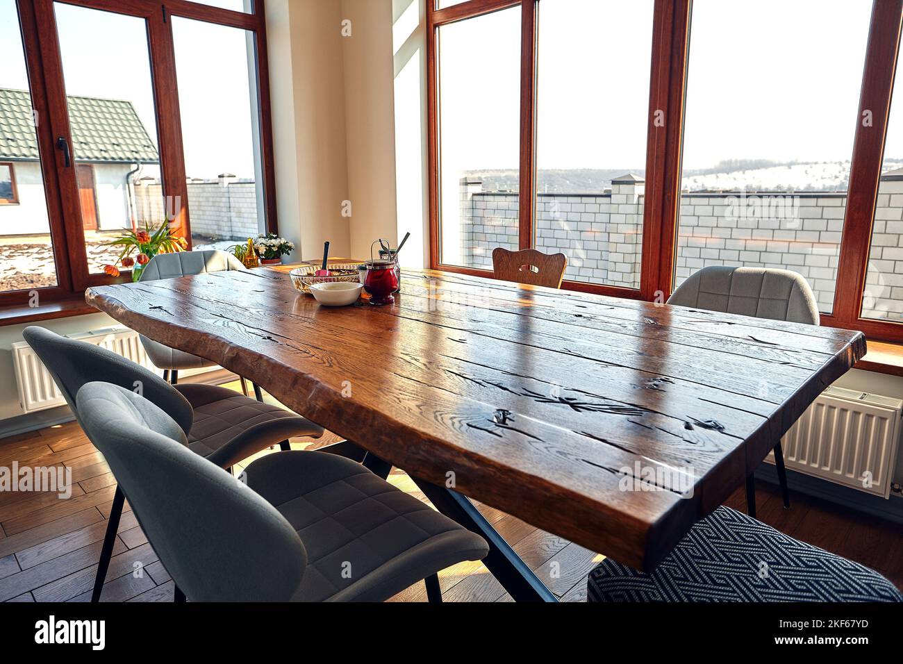 Interior of modern house, dining room with wooden table Stock Photo - Alamy