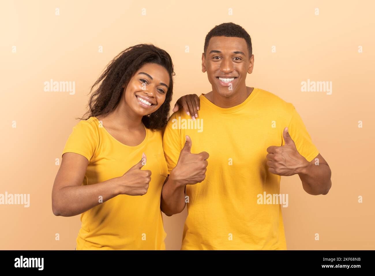 Best choice, we like it. Happy black couple showing thumbs up gesture ...