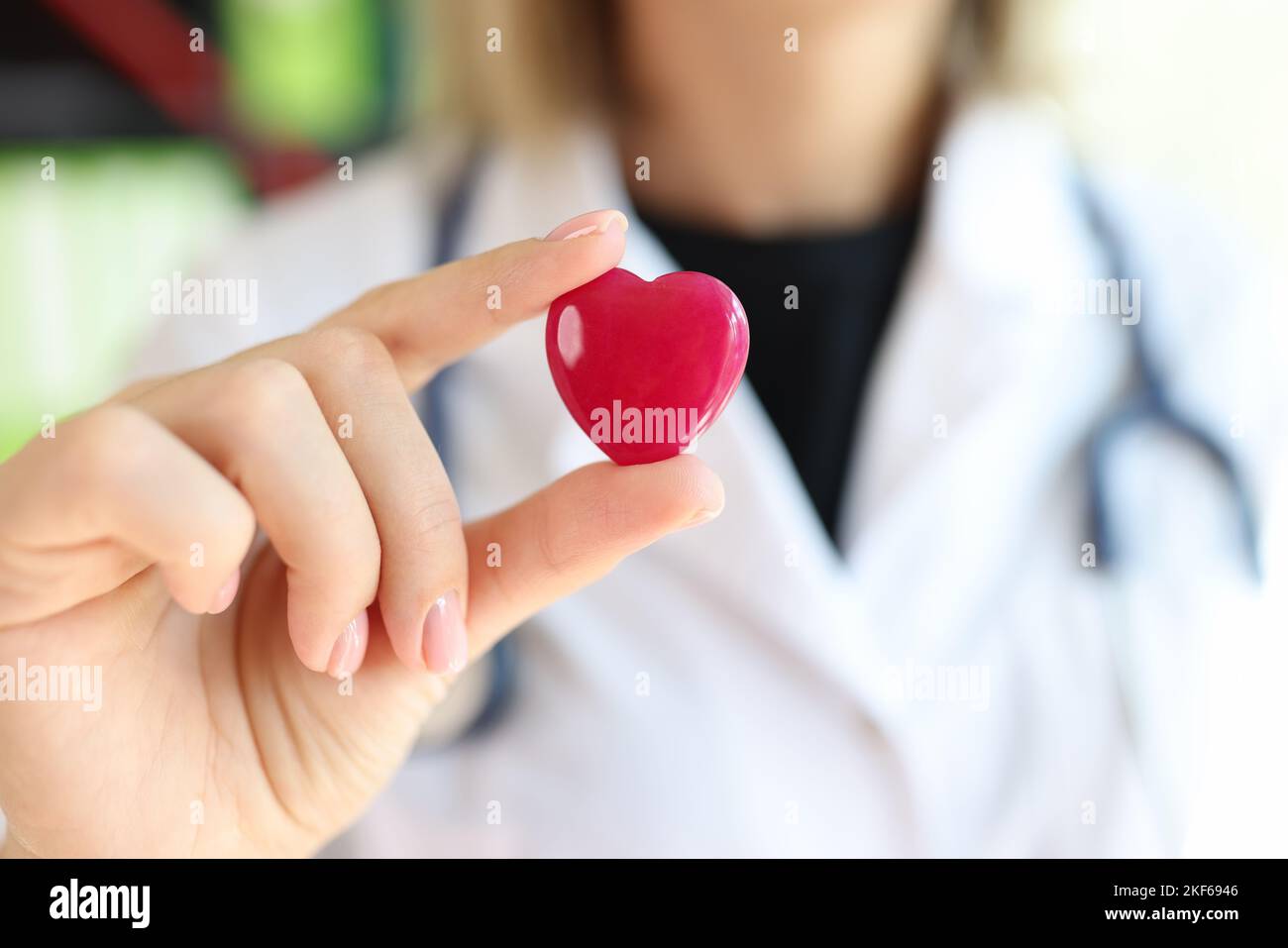 Female cardiologist with stethoscope holding red heart in hand Stock ...