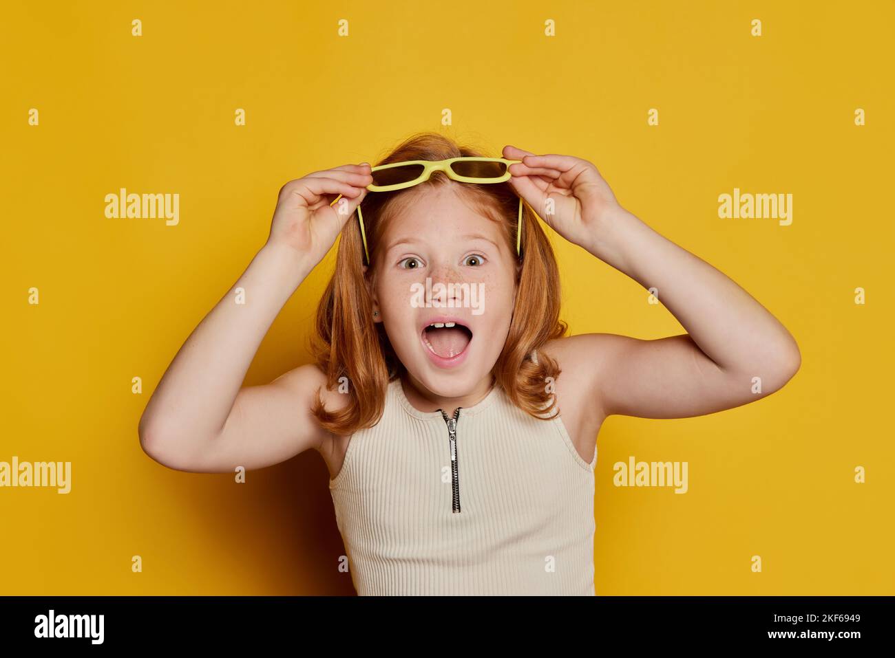 Wow. Surprised little girl with long red hair and freckles wearing ...
