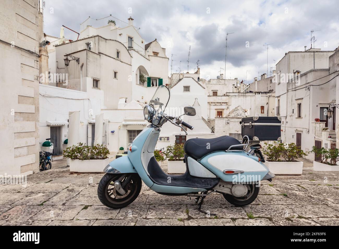View of the old town of Martina Franca. Classic blue moped on the ...