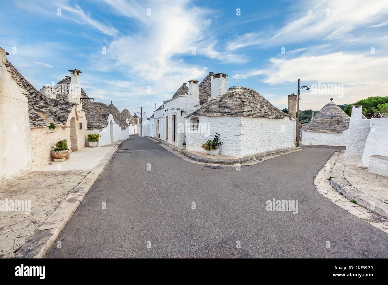 Beautiful town of Alberobello with Trulli houses among green plants and ...