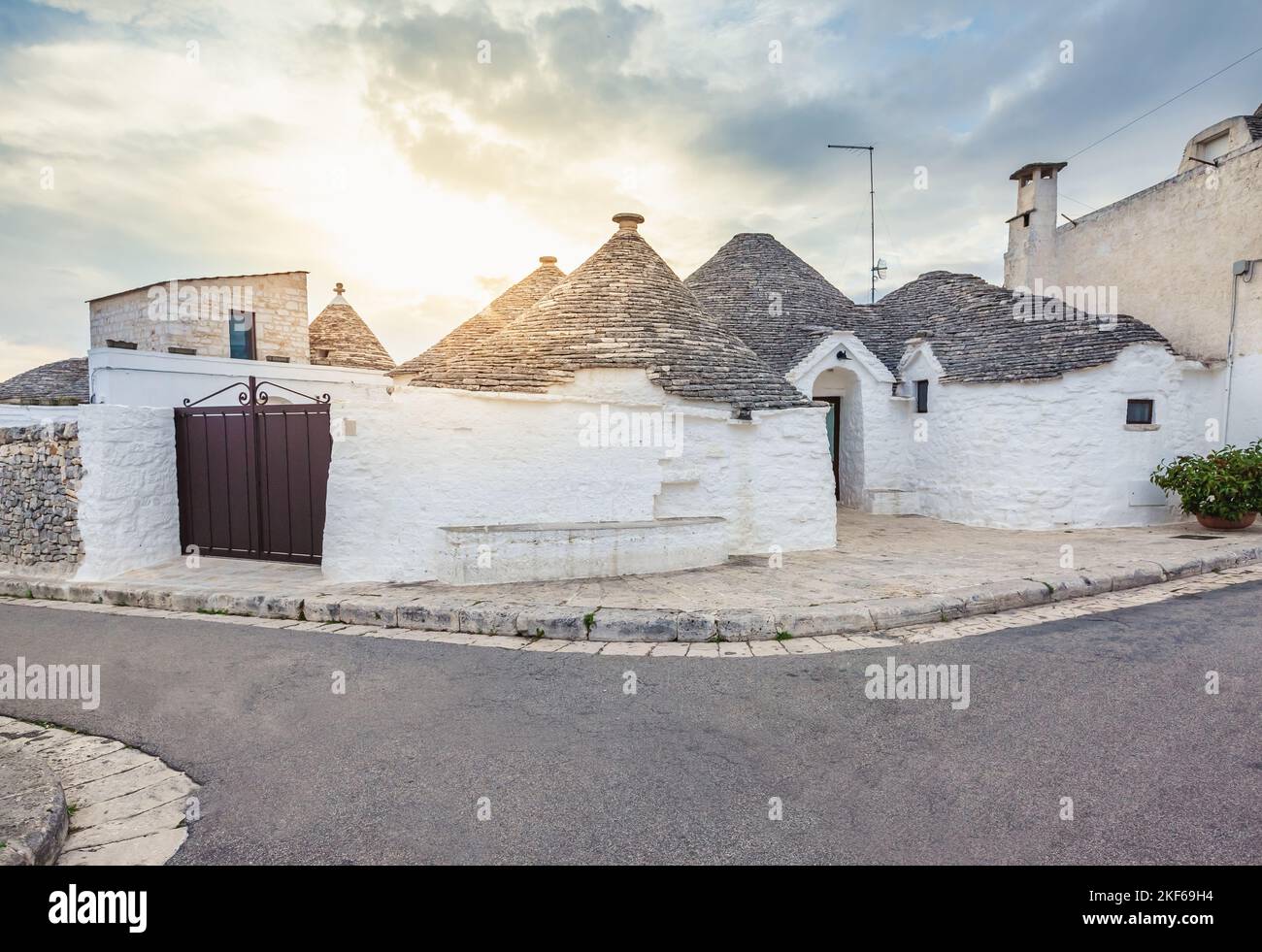 Beautiful town of Alberobello with Trulli houses among green plants and ...