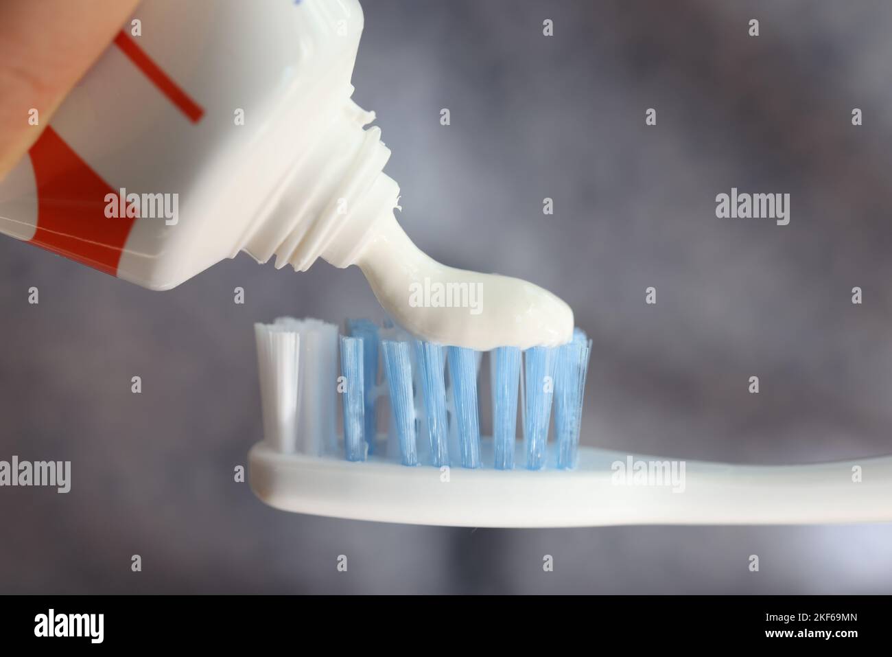 Closeup of squeezing toothpaste on toothbrush Stock Photo - Alamy