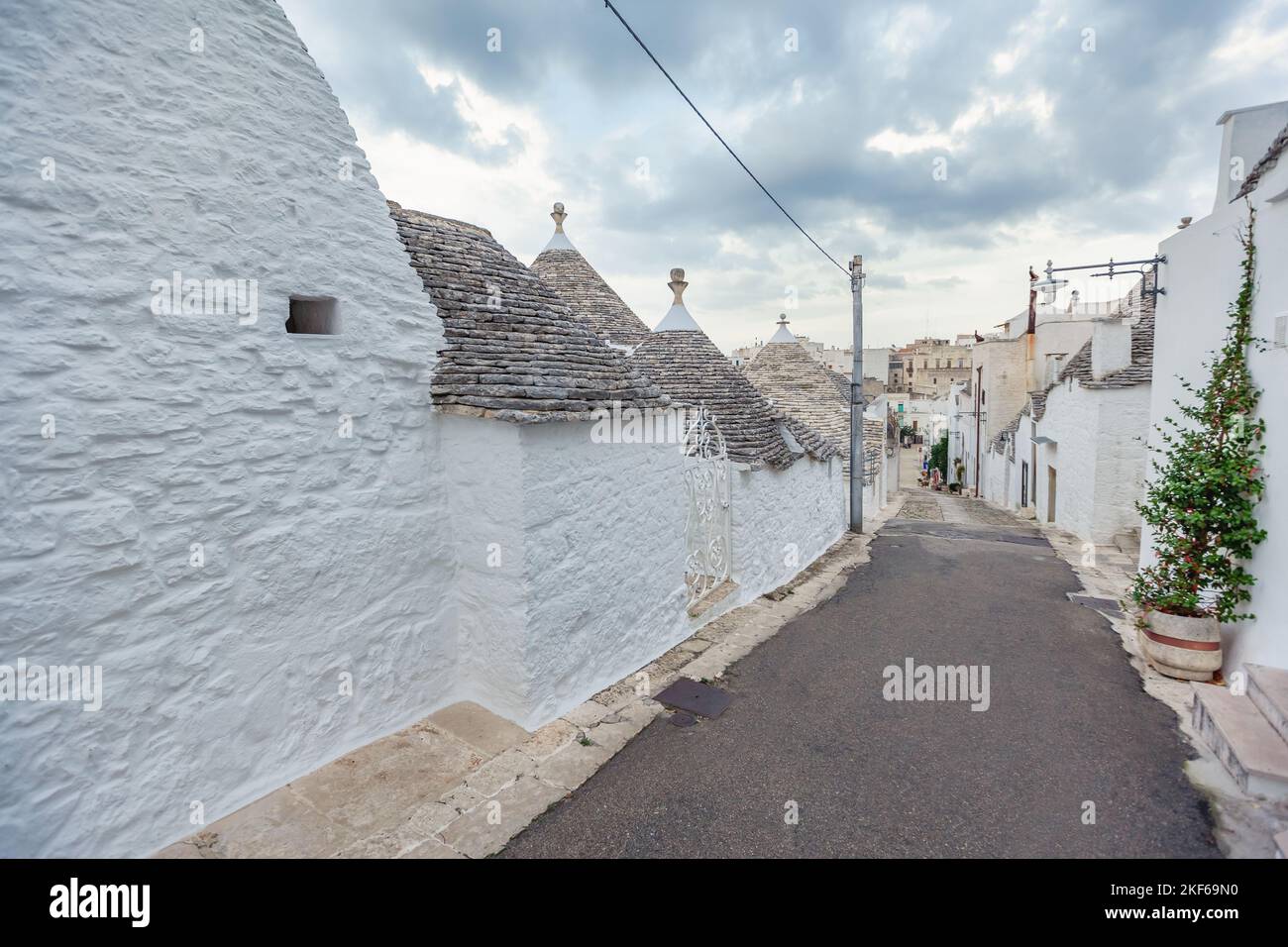 Beautiful town of Alberobello with Trulli houses among green plants and ...