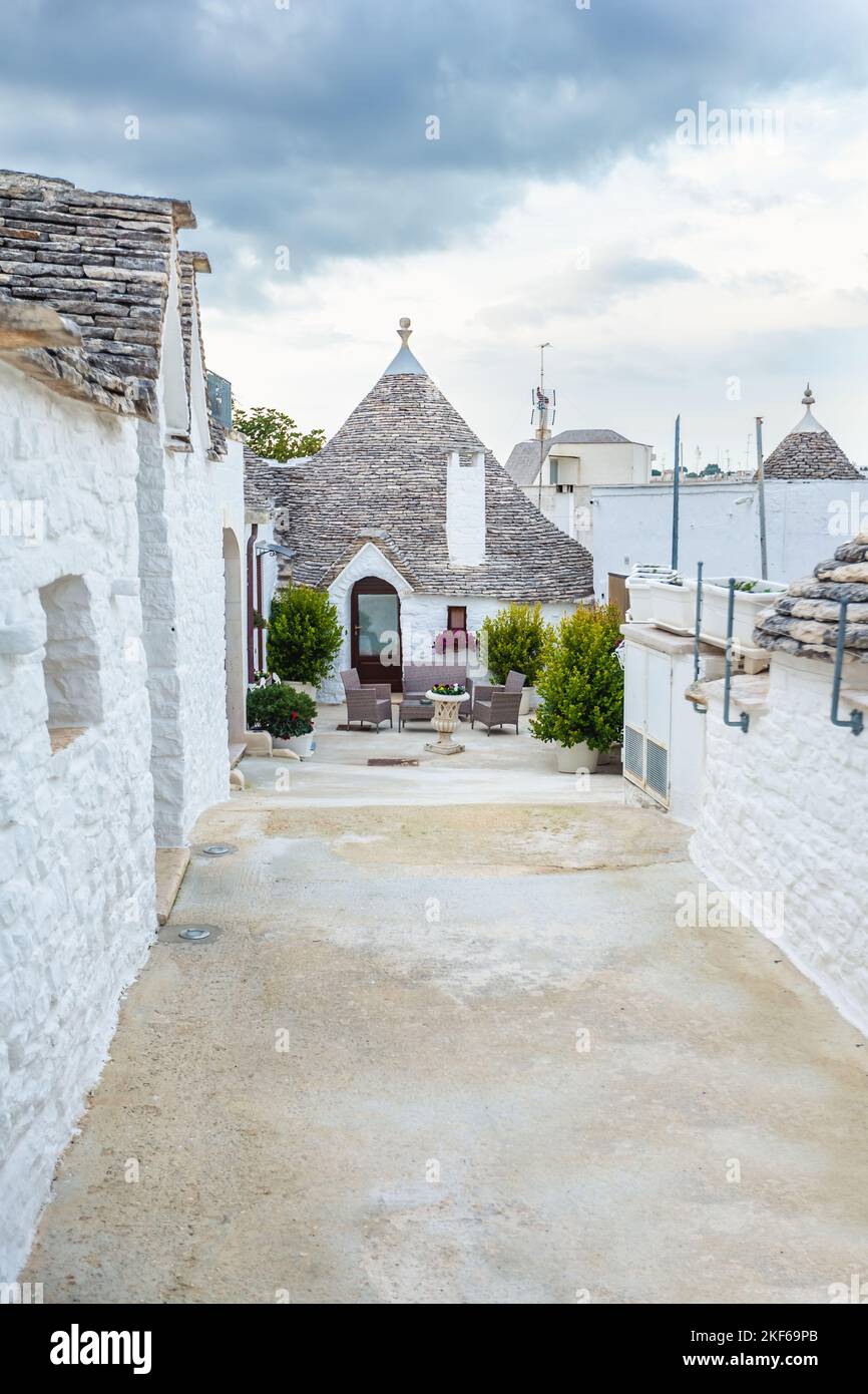 Beautiful town of Alberobello with Trulli houses among green plants and ...