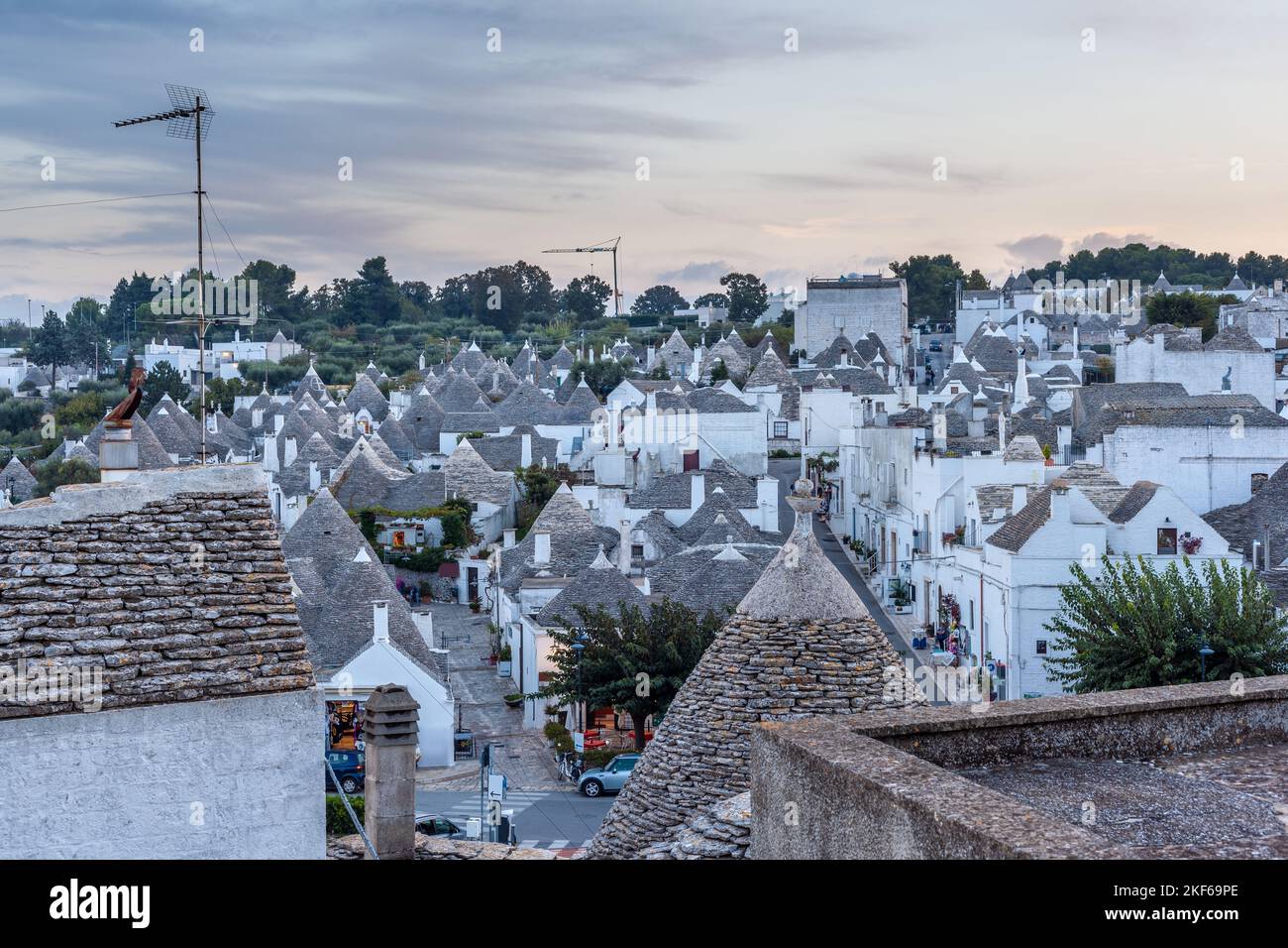 Beautiful town of Alberobello with Trulli houses among green plants and ...