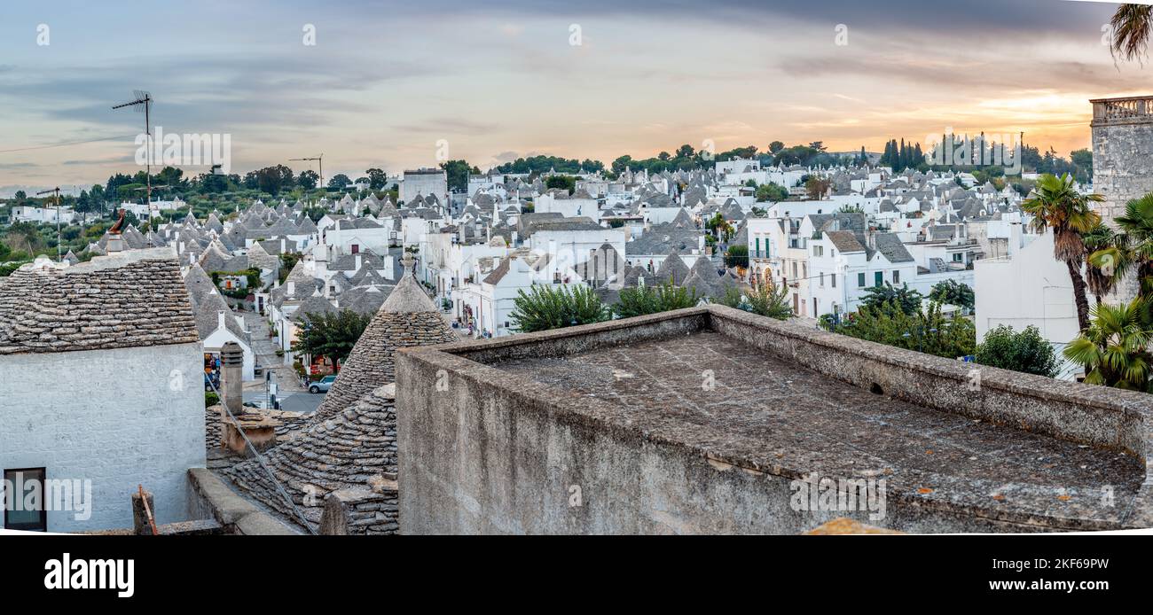 Beautiful town of Alberobello with Trulli houses among green plants and ...