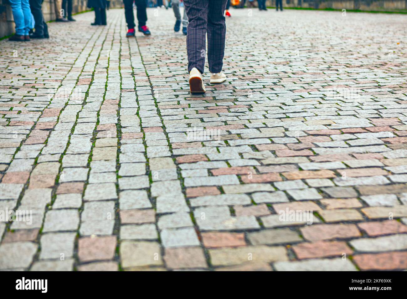 Walking legs at pavement . Feet at cobblestone Stock Photo - Alamy