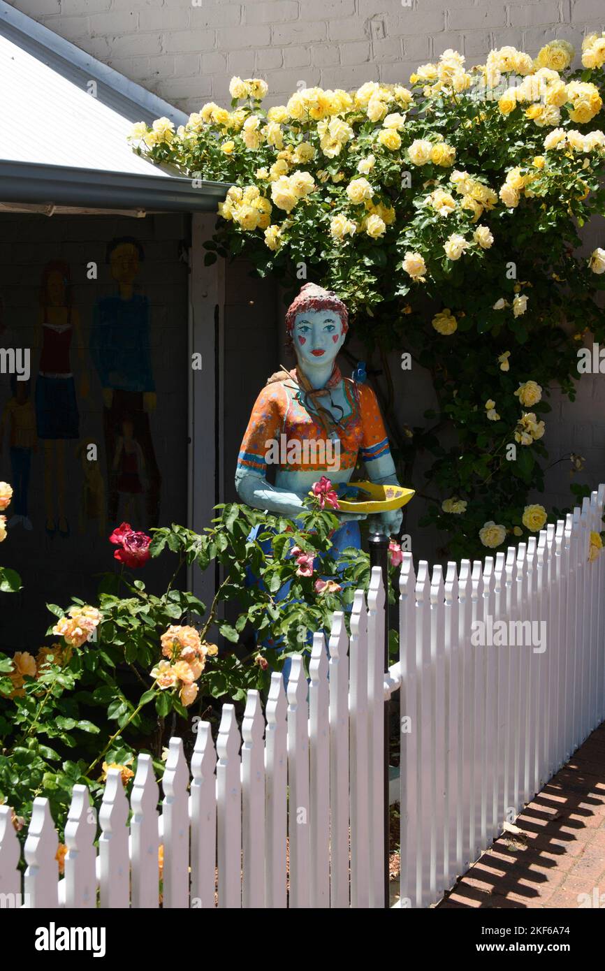 Life-size statue and roses in cottage garden. Toodyay, Western ...