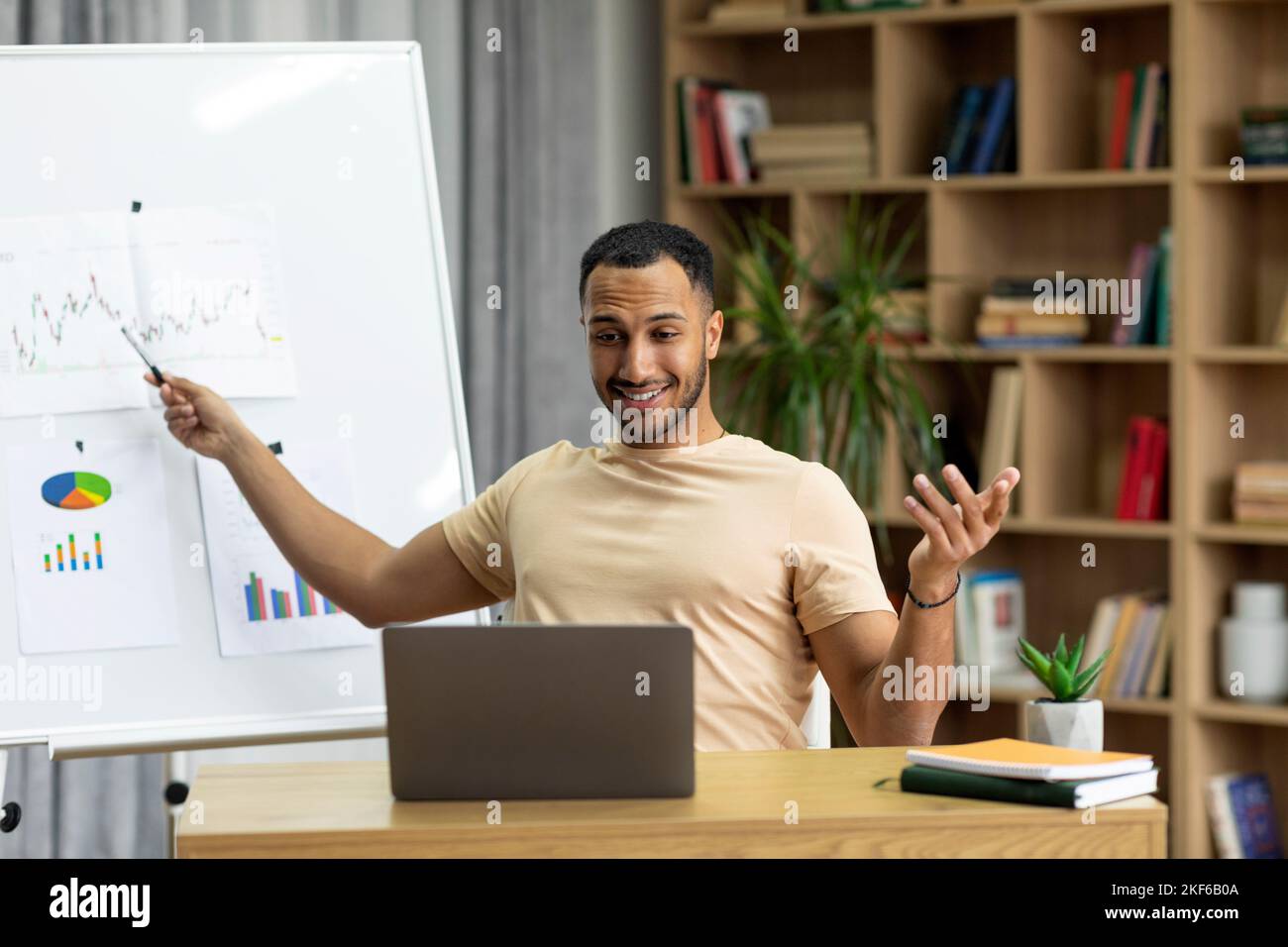 Happy arab man teaching online talking to laptop webcamera, having ...