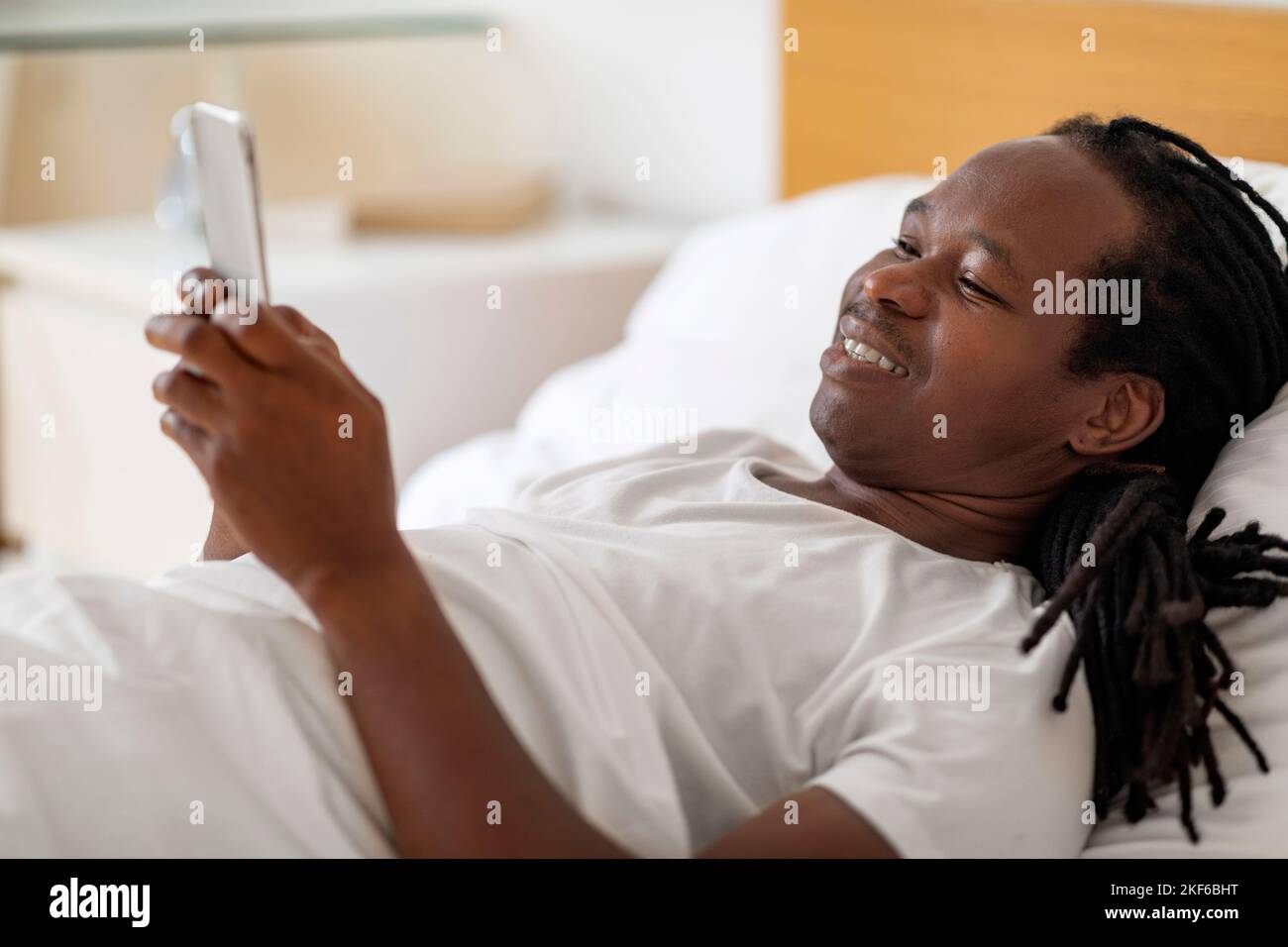 Gadget Addiction. Black Man Browsing Internet On Smartphone While ...