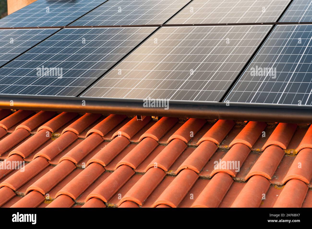 Solar panels are mounted on a red Italian tile roof to produce solar ...