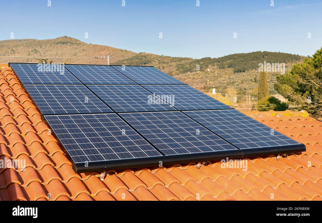 Solar panels are mounted on a red Italian tile roof to produce solar ...