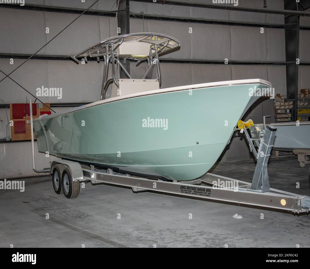 An image of a newly built turquoise boat standing inside a building ...