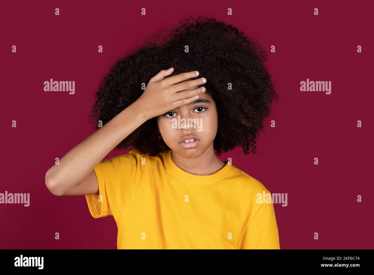 Embarrassed african american girl holding hand on forehead Stock Photo ...
