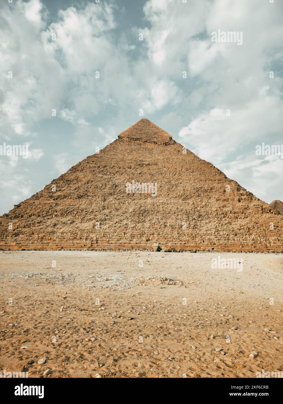 A vertical shot of the Great Pyramid of Giza with fluffy clouds in the sky Stock Photo - Alamy