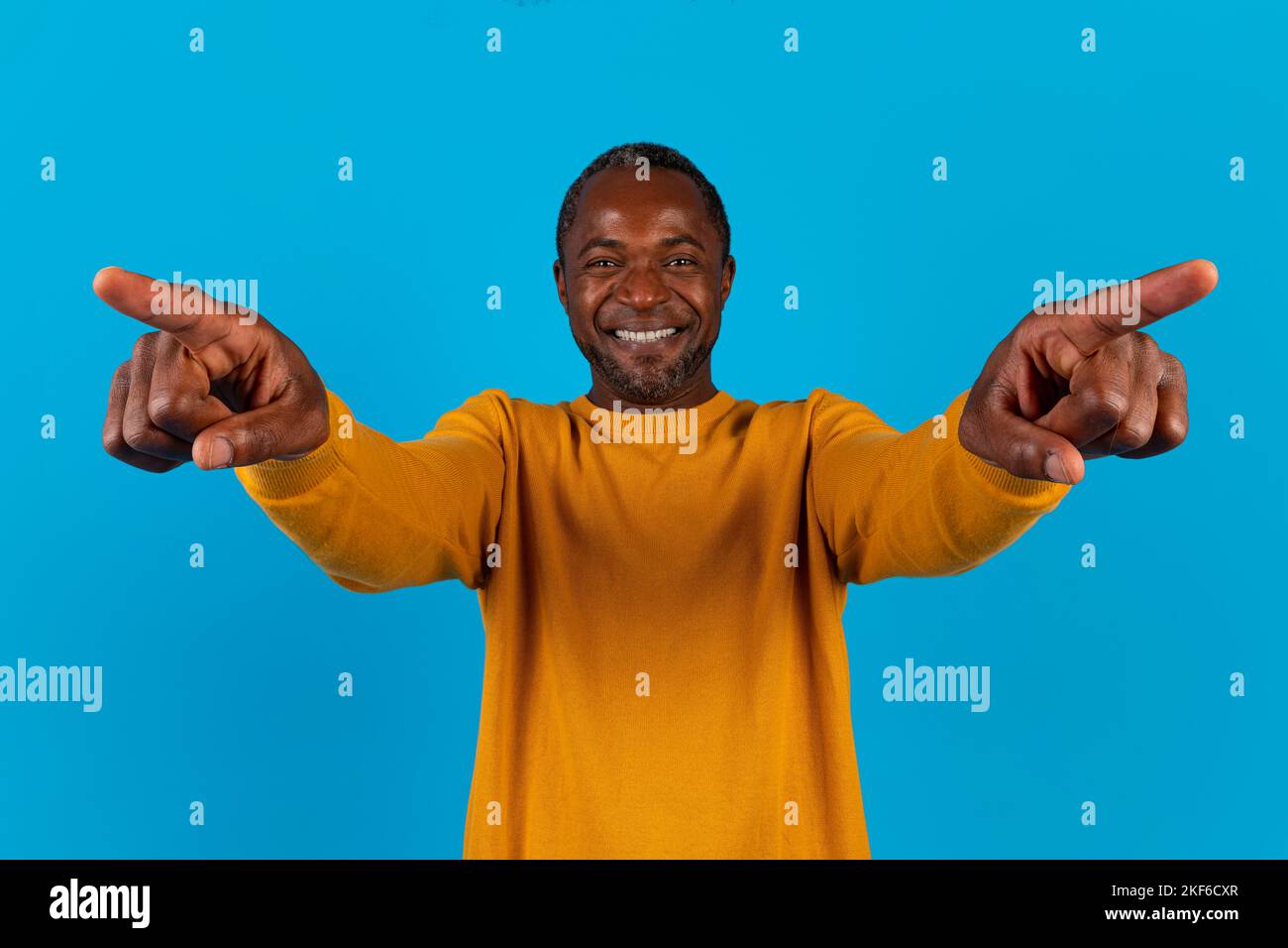 Charismatic handsome black man pointing fingers at camera and smiling ...