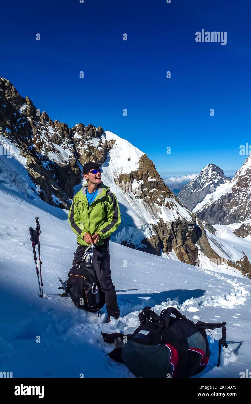 Description: Speedflying pilot enjoying mountain scenery snowy slope ...