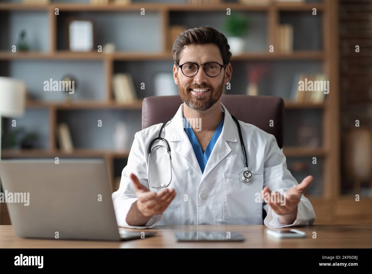 Medical Consultation. Handsome Male Doctor Sitting At Desk And Talking ...