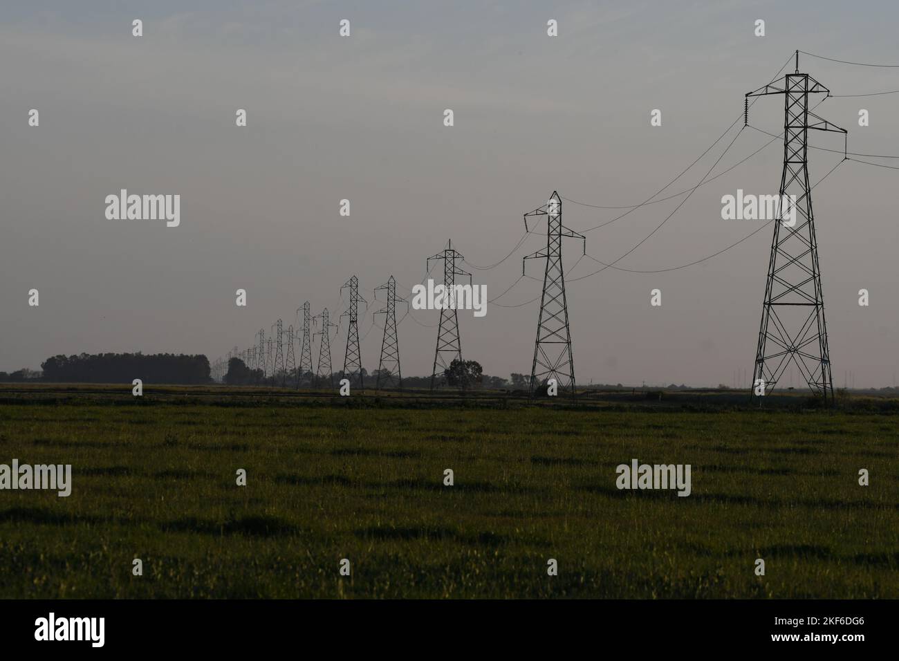 An electric power lines in the field Stock Photo - Alamy