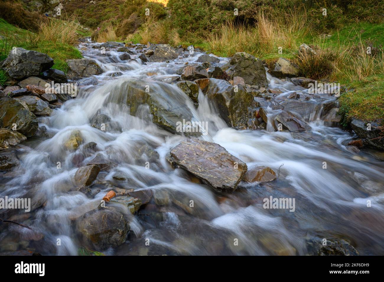 Stream with flowing water over rocks Stock Photo - Alamy
