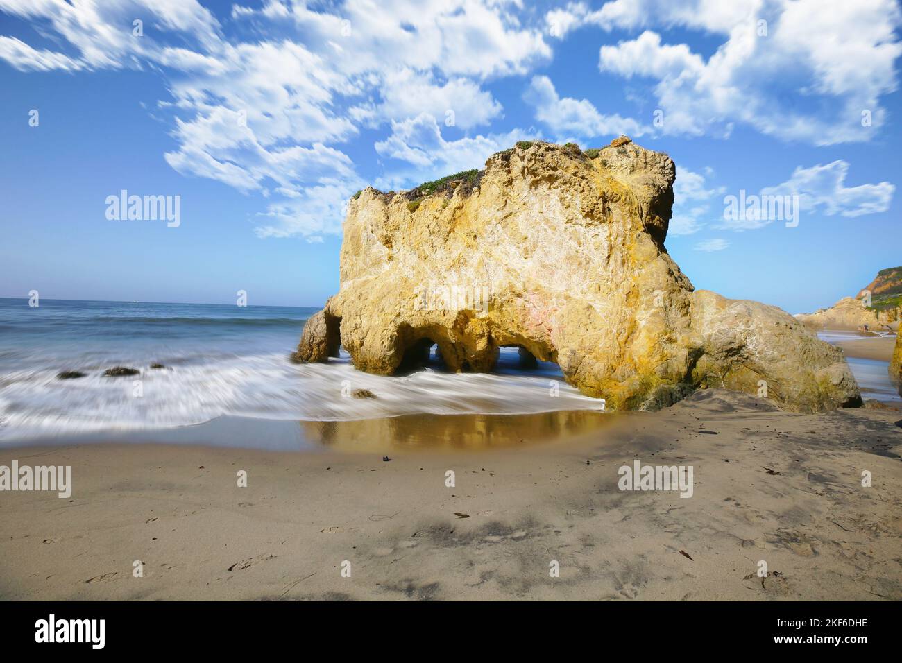 A huge rock in the ocean beach Stock Photo - Alamy