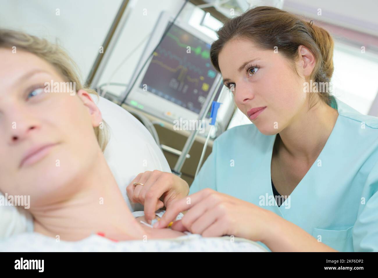nurse caring for female patient Stock Photo - Alamy