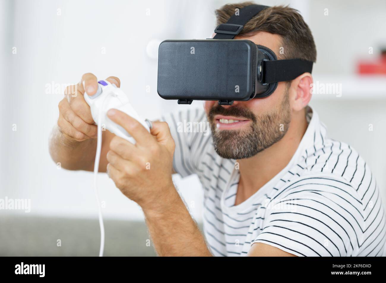 bearded gamer playing game using joystick and virtual reality headset ...