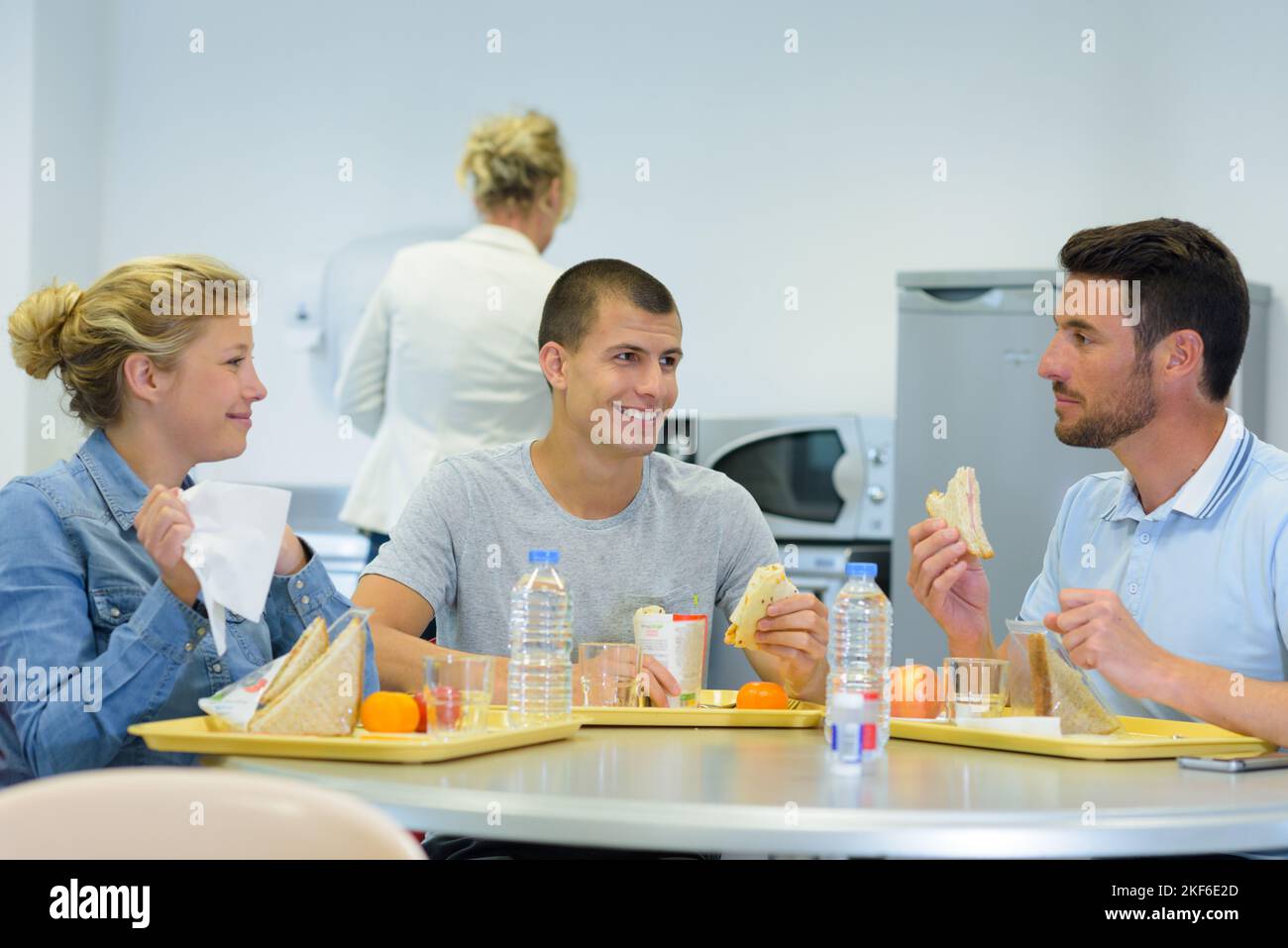 colleagues eating their sandwiches around table in staffroom Stock ...