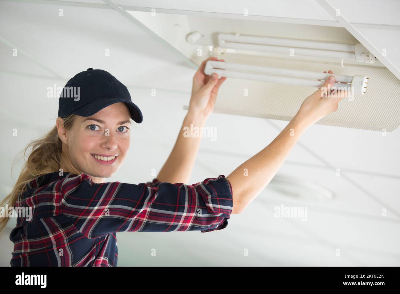 a woman changing light bulb Stock Photo - Alamy