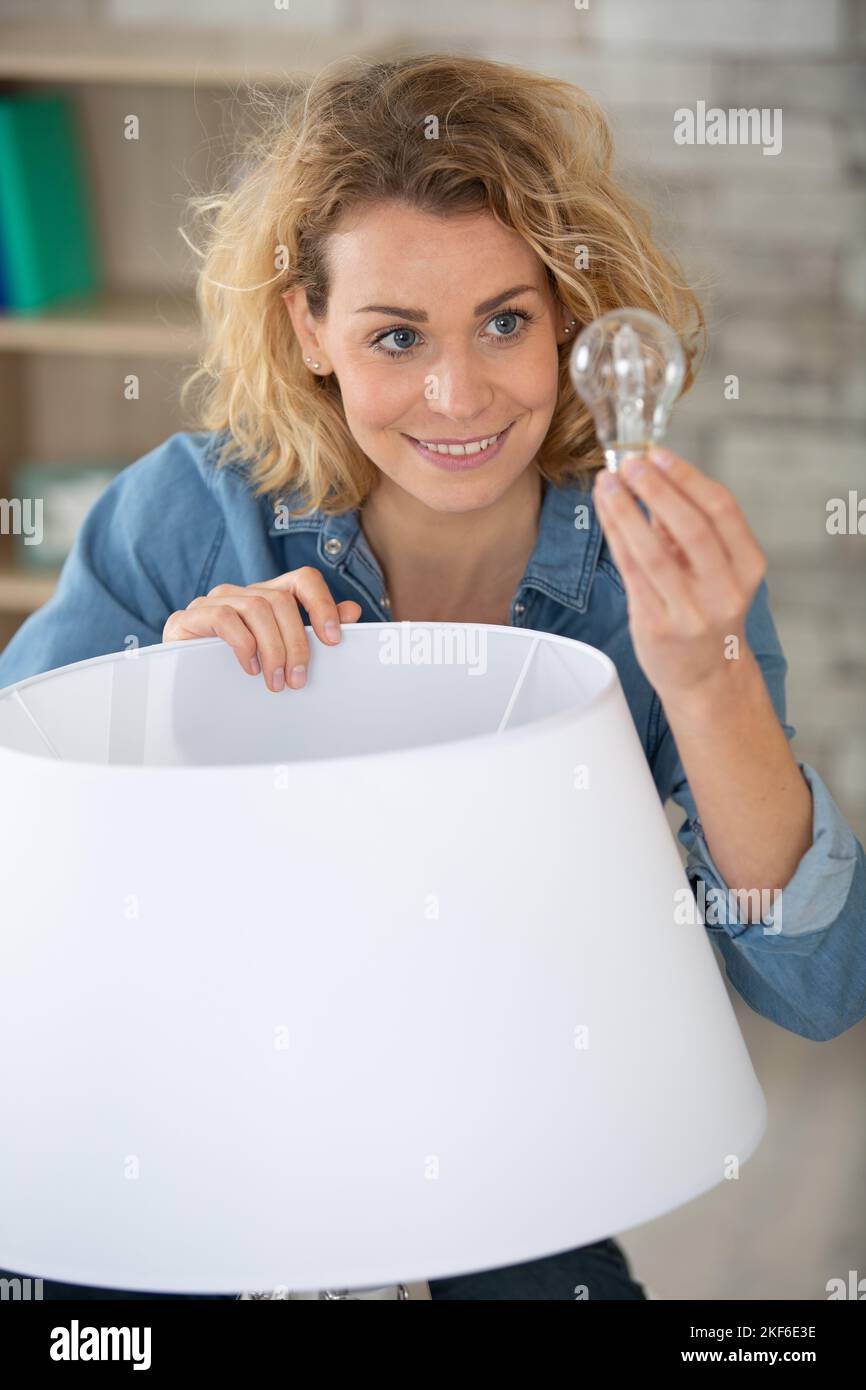 woman changing light bulb in lamp at home Stock Photo - Alamy