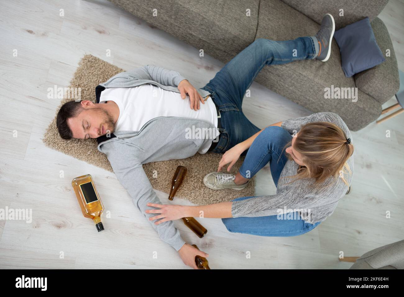 woman is taking care of drunken man Stock Photo - Alamy