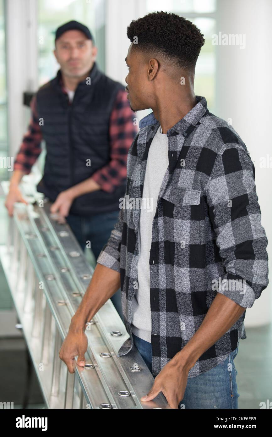 Construction worker ladder holding help hi-res stock photography and ...