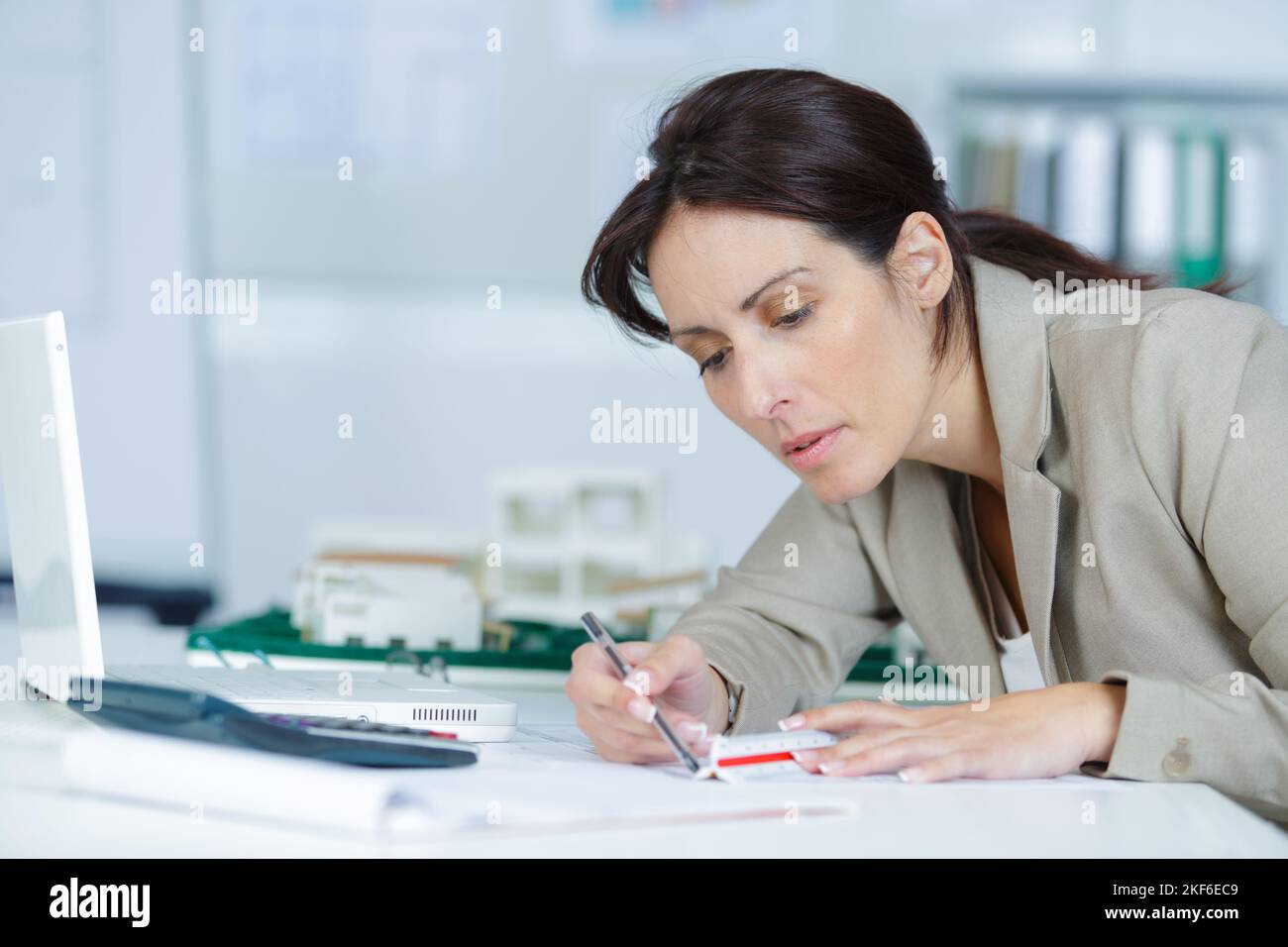 Woman architect using building model hi-res stock photography and ...