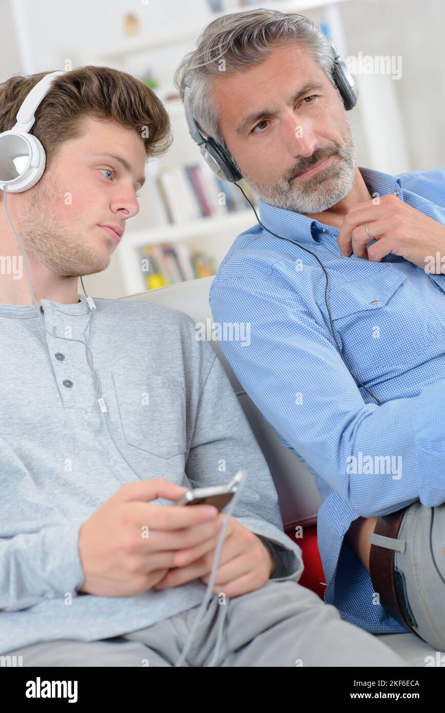 father and son listening music together Stock Photo - Alamy