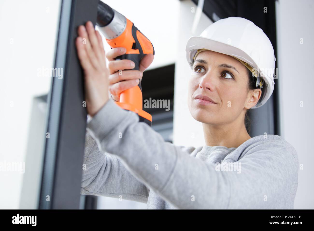 construction worker drilling a window Stock Photo - Alamy