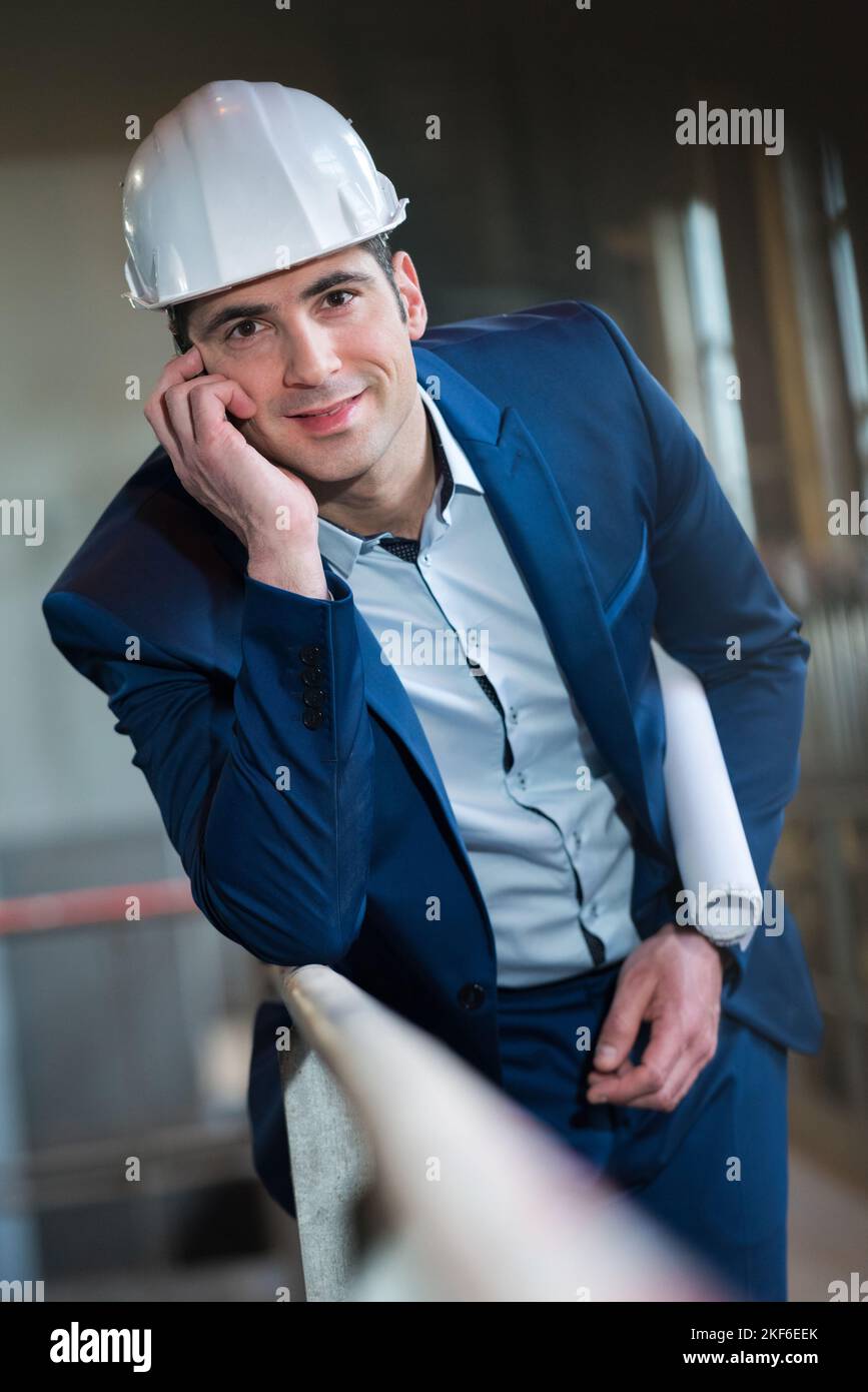 male engineer with helmet holding blueprints Stock Photo - Alamy
