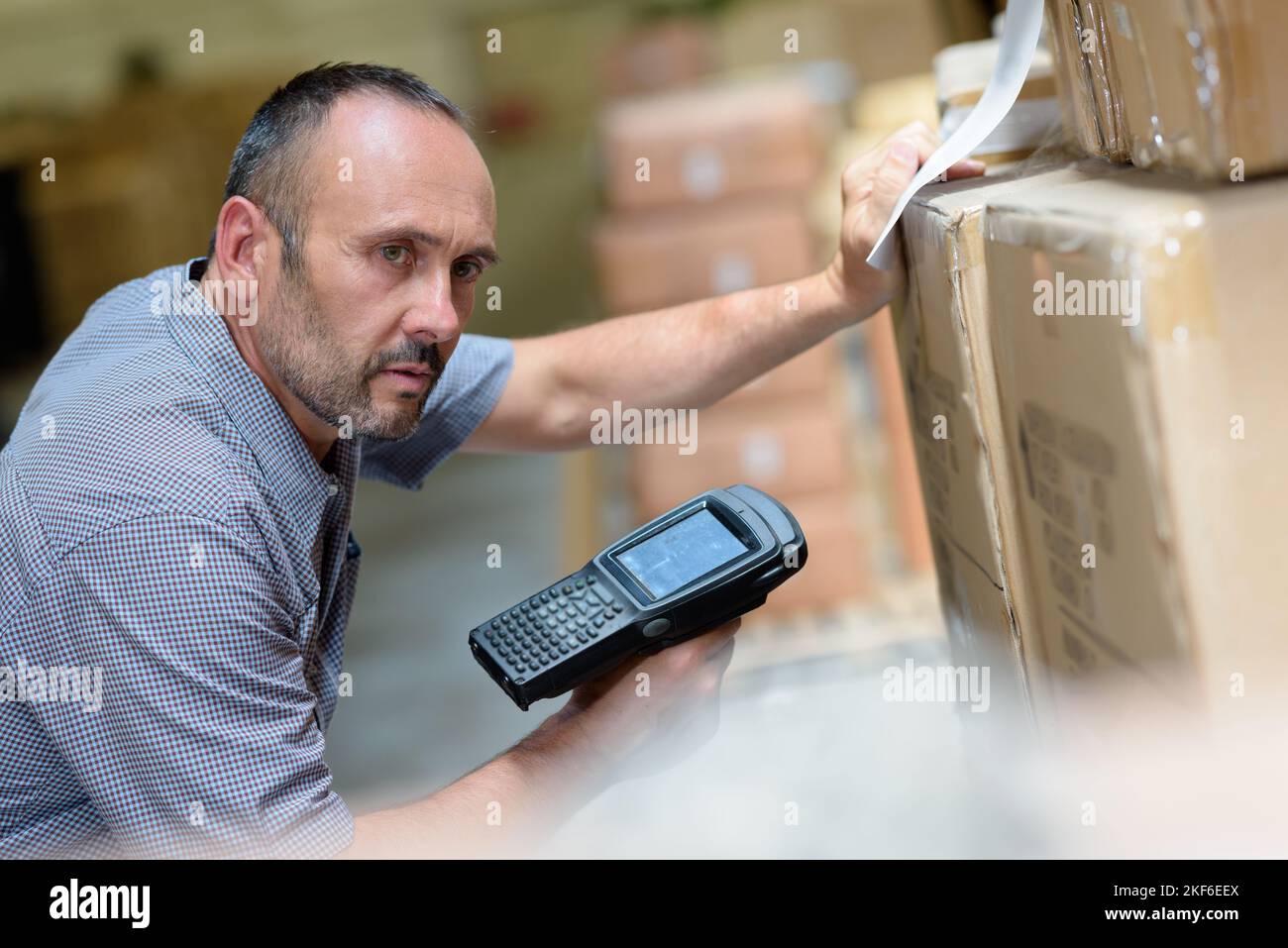 worker in charge of scanning boxes with problematic expression Stock ...