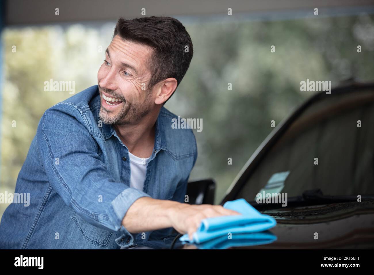 Happy man touching car in hi-res stock photography and images - Alamy