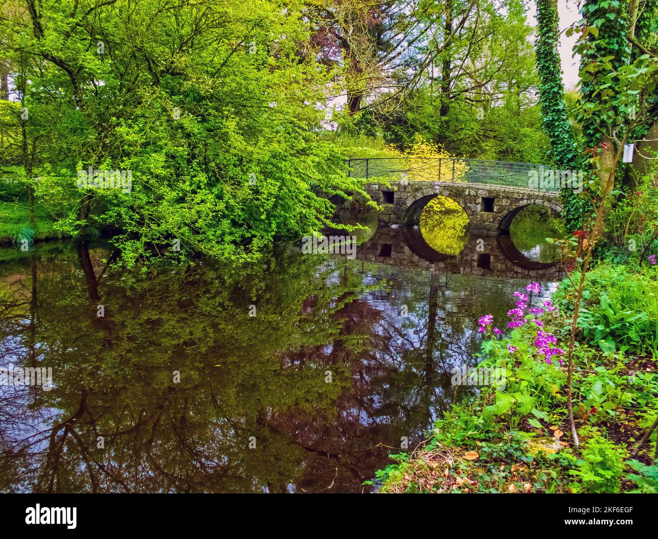 Arched stone bridge over a pond in the gardens Stock Photo - Alamy