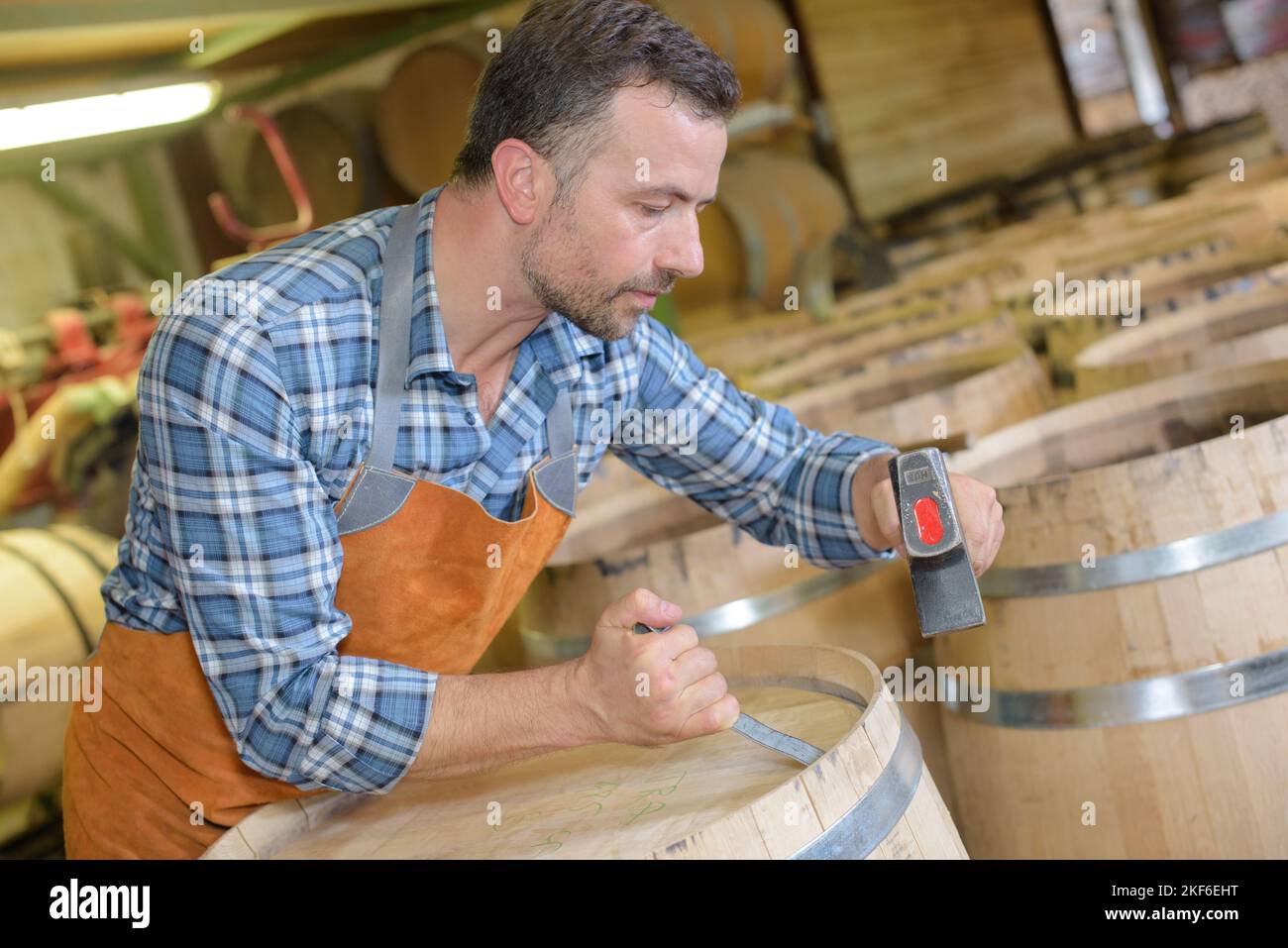 wood barrels production cooper using hammer and tools in workshop Stock ...